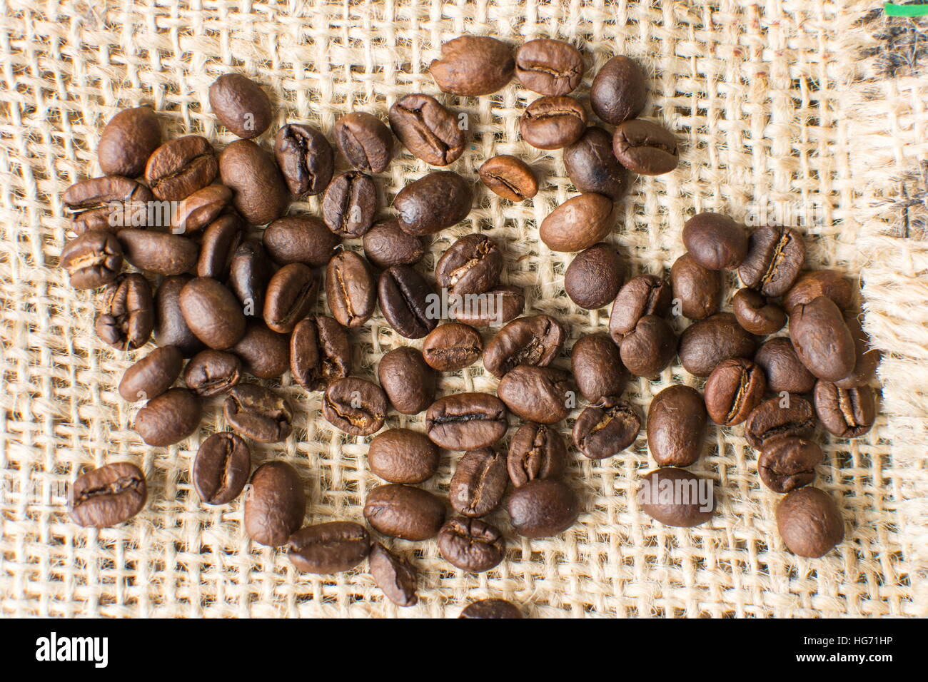 Roasted coffee beans on a rustic bag Stock Photo - Alamy