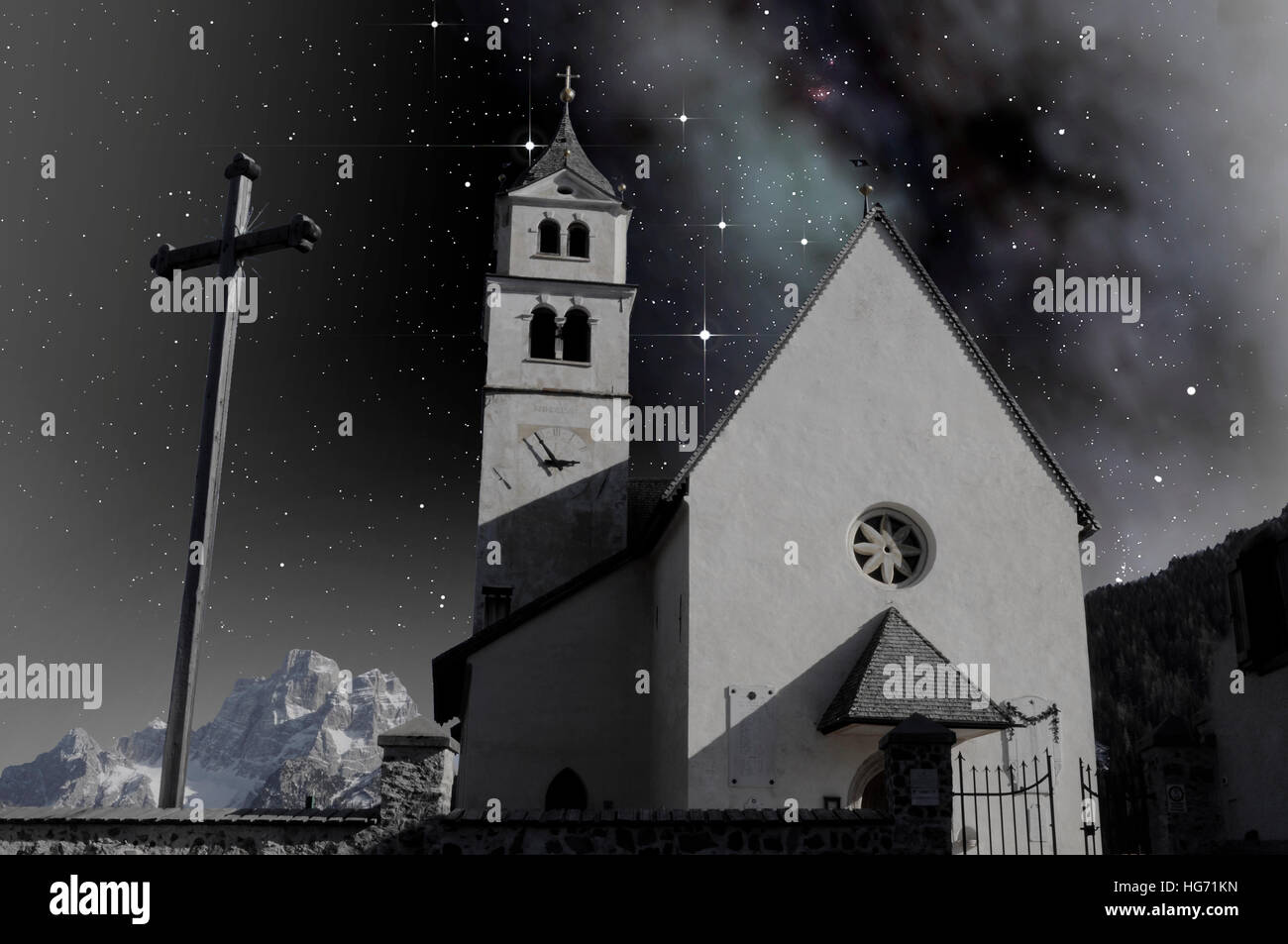 Night view of a small church under the starry sky in alpine landscape ...