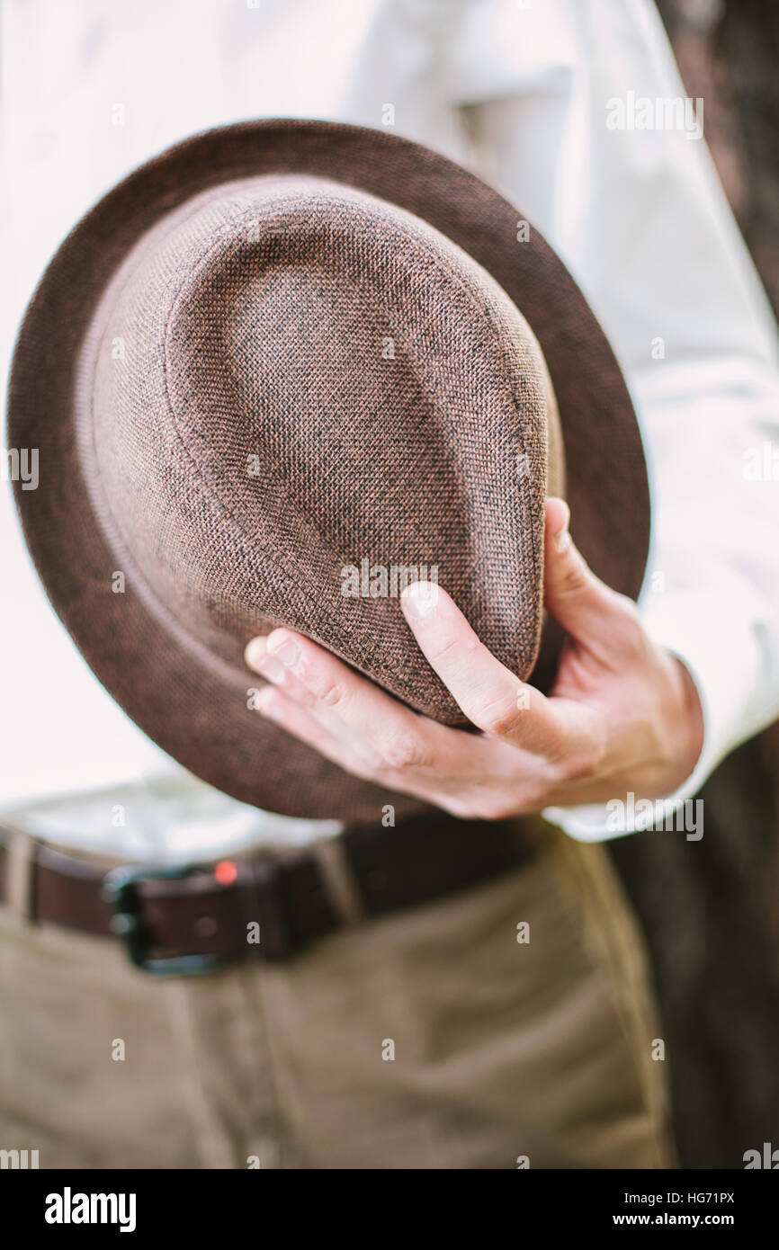 the man holds a trilby hat in hand Stock Photo - Alamy