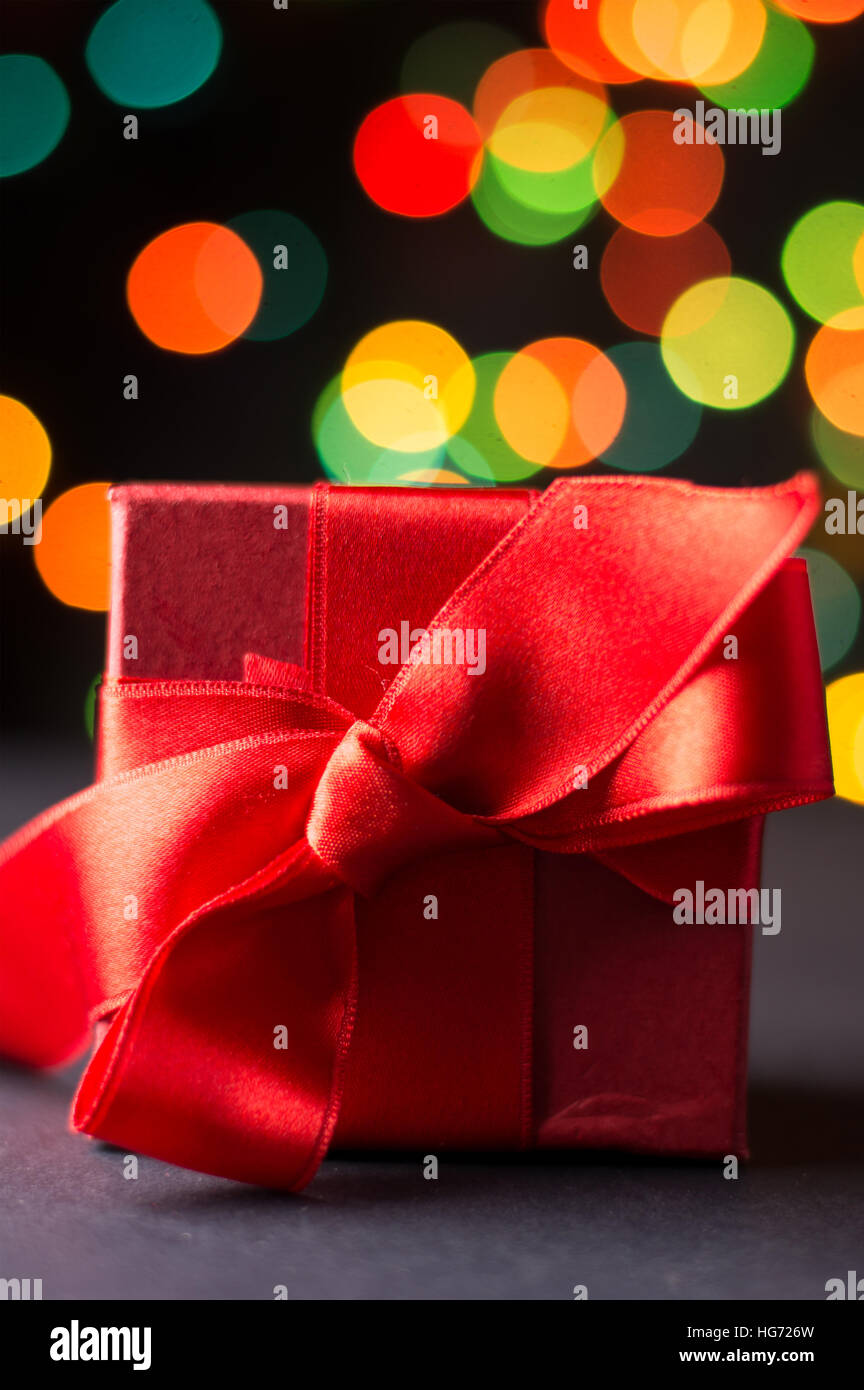 Red present box with colorful bokeh lights background Stock Photo - Alamy