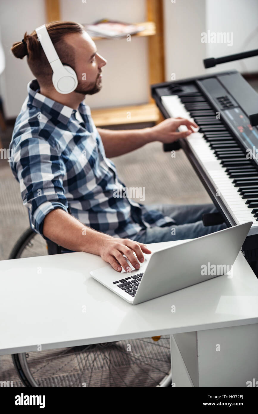 Focused disabled composer working on a new tracks Stock Photo - Alamy