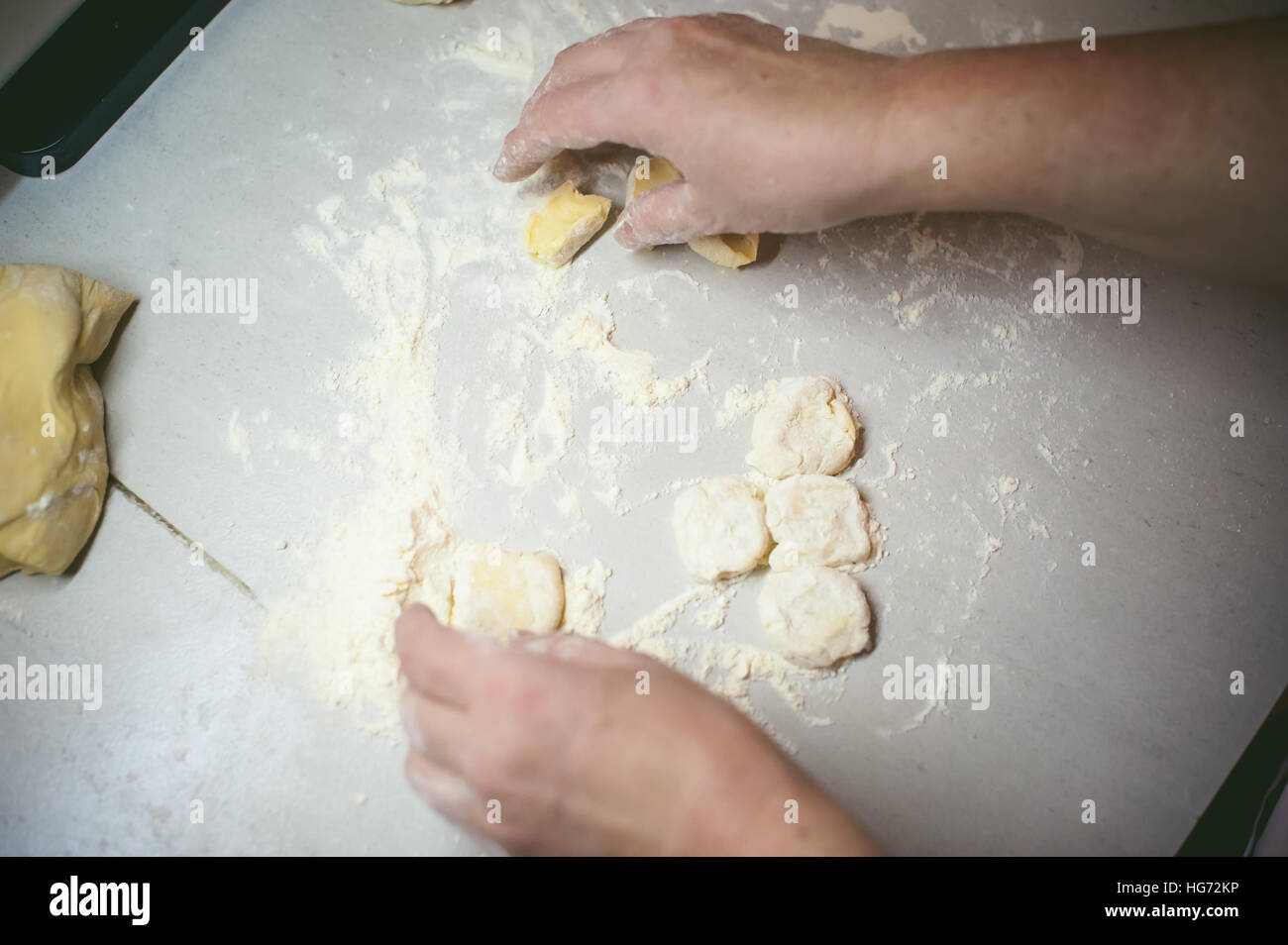 hand modeling dumplings at home in the kitchen. hands and the dough ...