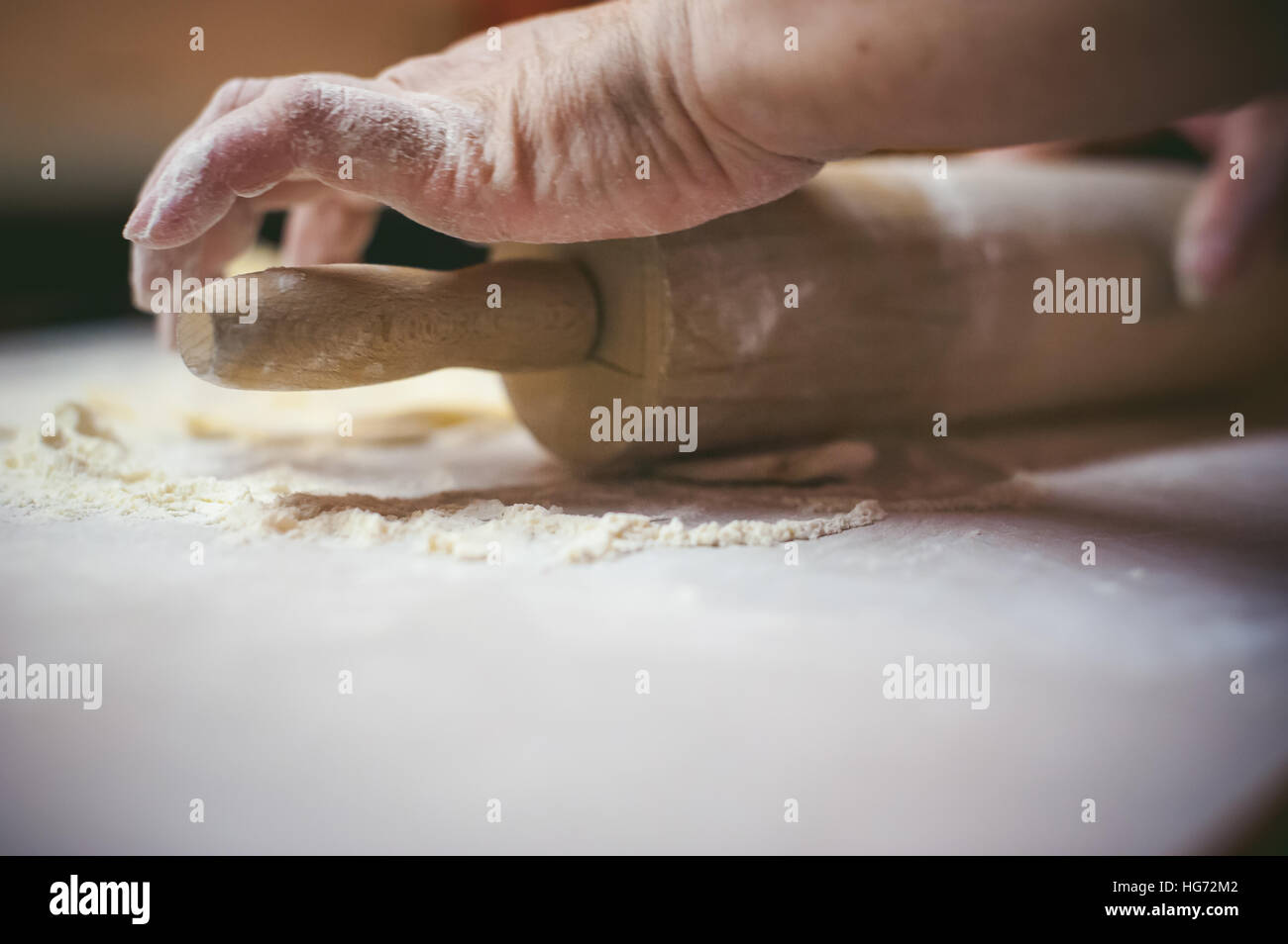 hand modeling dumplings at home in the kitchen. rolling pin in hand ...