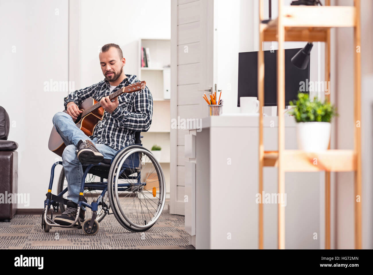 Devoted handicapped man playing musical instrument Stock Photo - Alamy