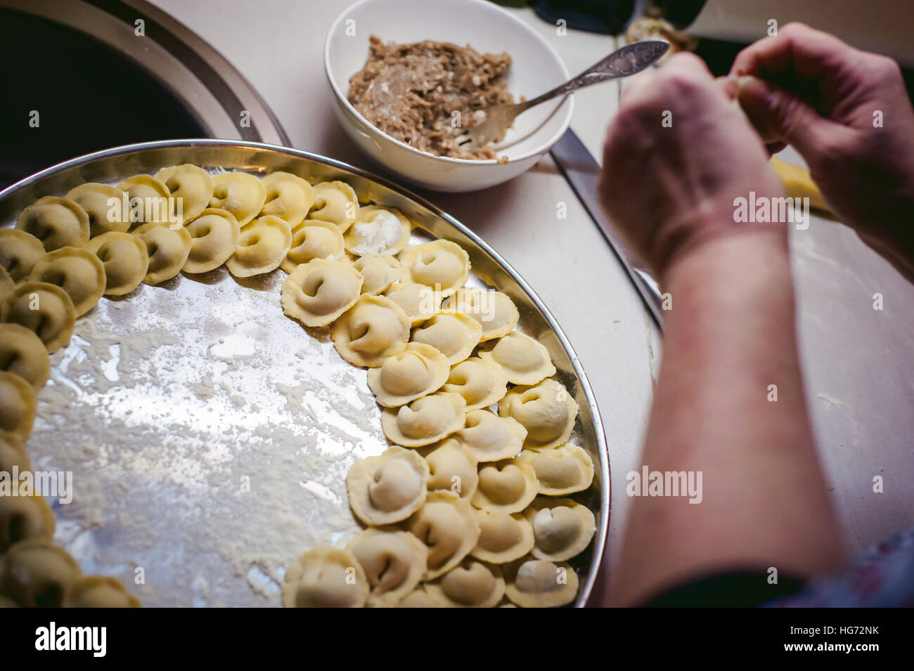 hand modeling dumplings at home in the kitchen Stock Photo - Alamy
