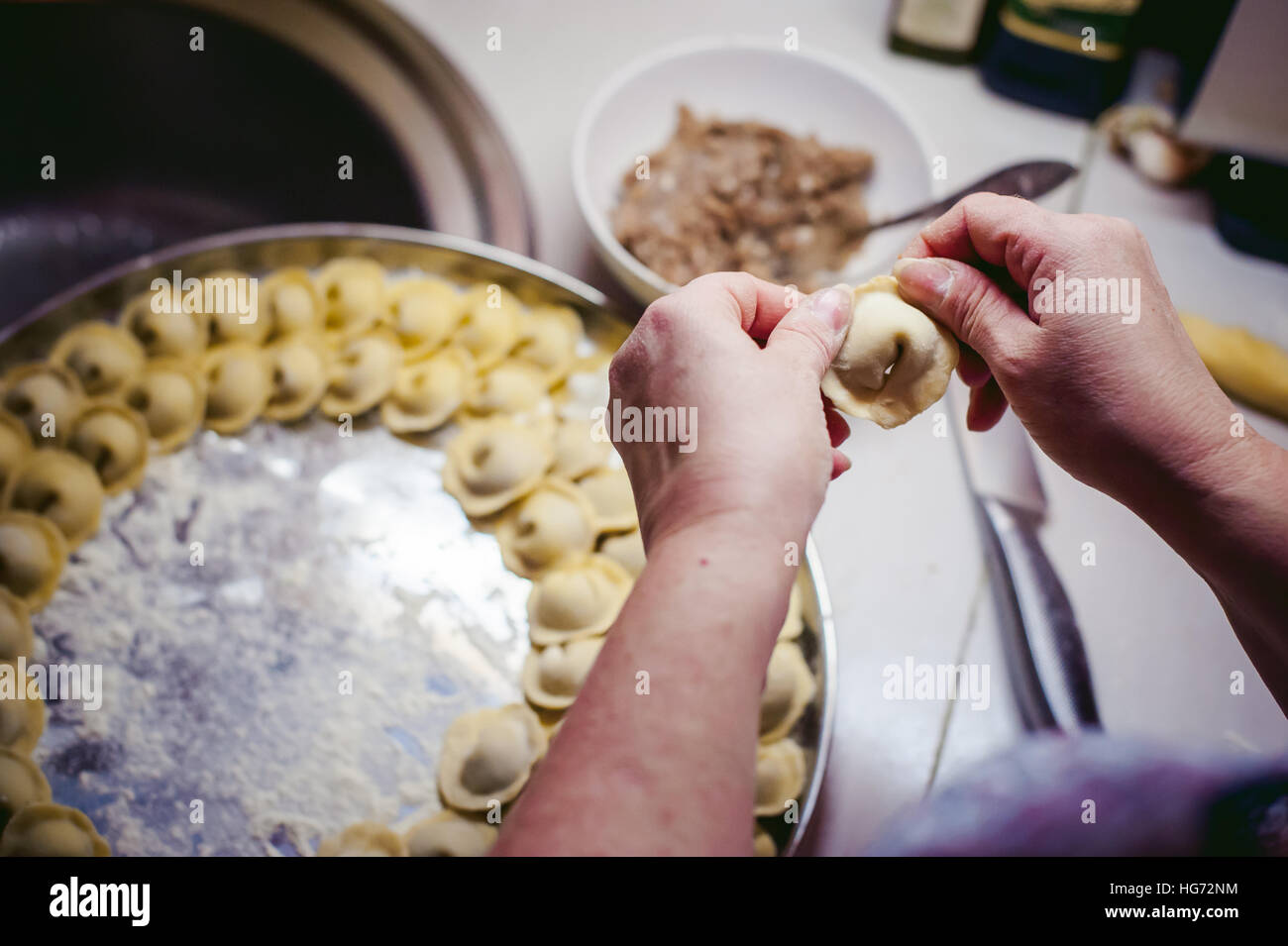 hand modeling dumplings at home in the kitchen Stock Photo - Alamy