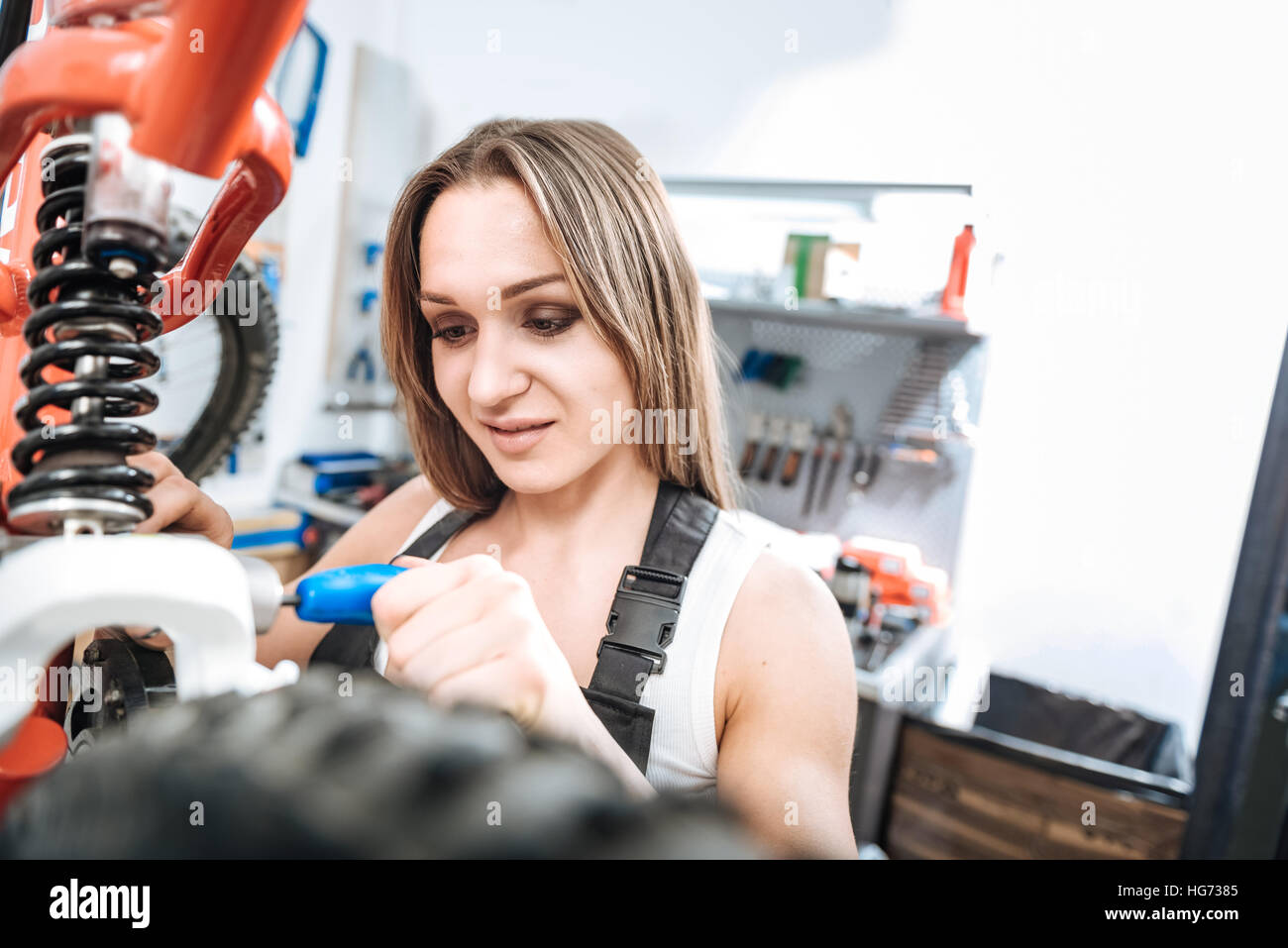 Cheerful smiling mechanic working in the garage Stock Photo - Alamy