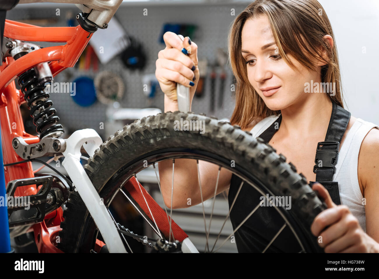 Skillful female technician working in the repair shop Stock Photo - Alamy