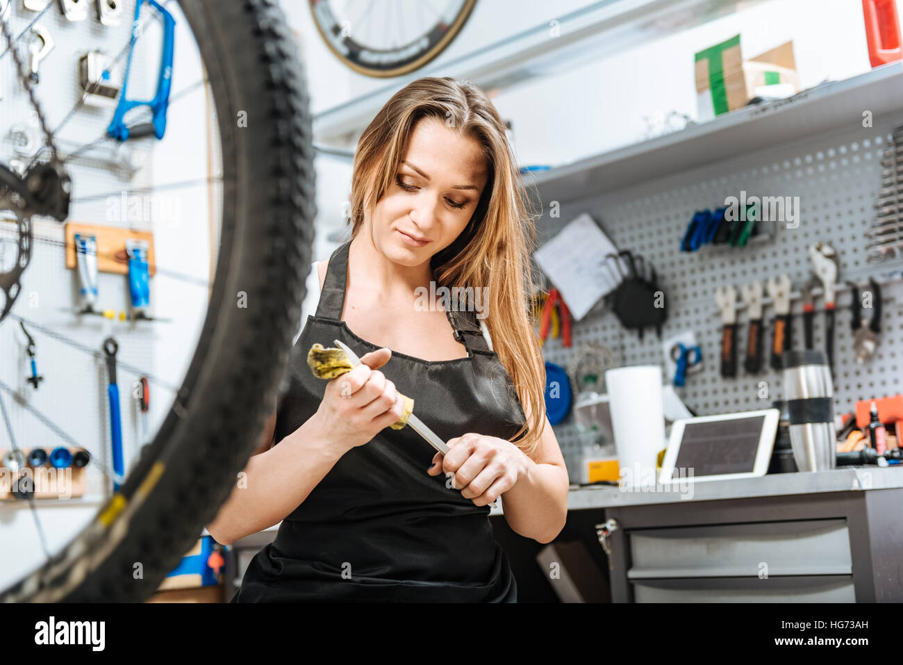 Concentrated female mechanic working in the repair shop Stock Photo - Alamy