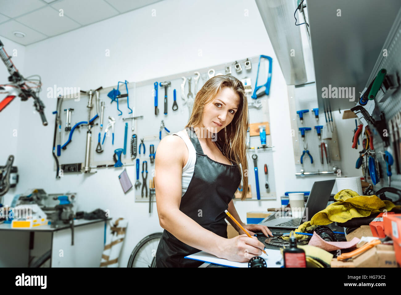 Beautiful female technician drawing a draft in the workshop Stock Photo ...
