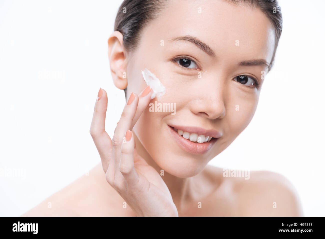 Positive charming woman caring about her face Stock Photo - Alamy