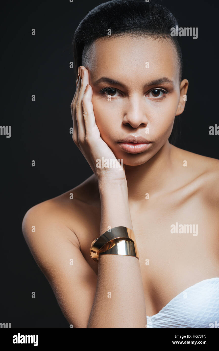 Beautiful cute woman touching her cheek Stock Photo - Alamy