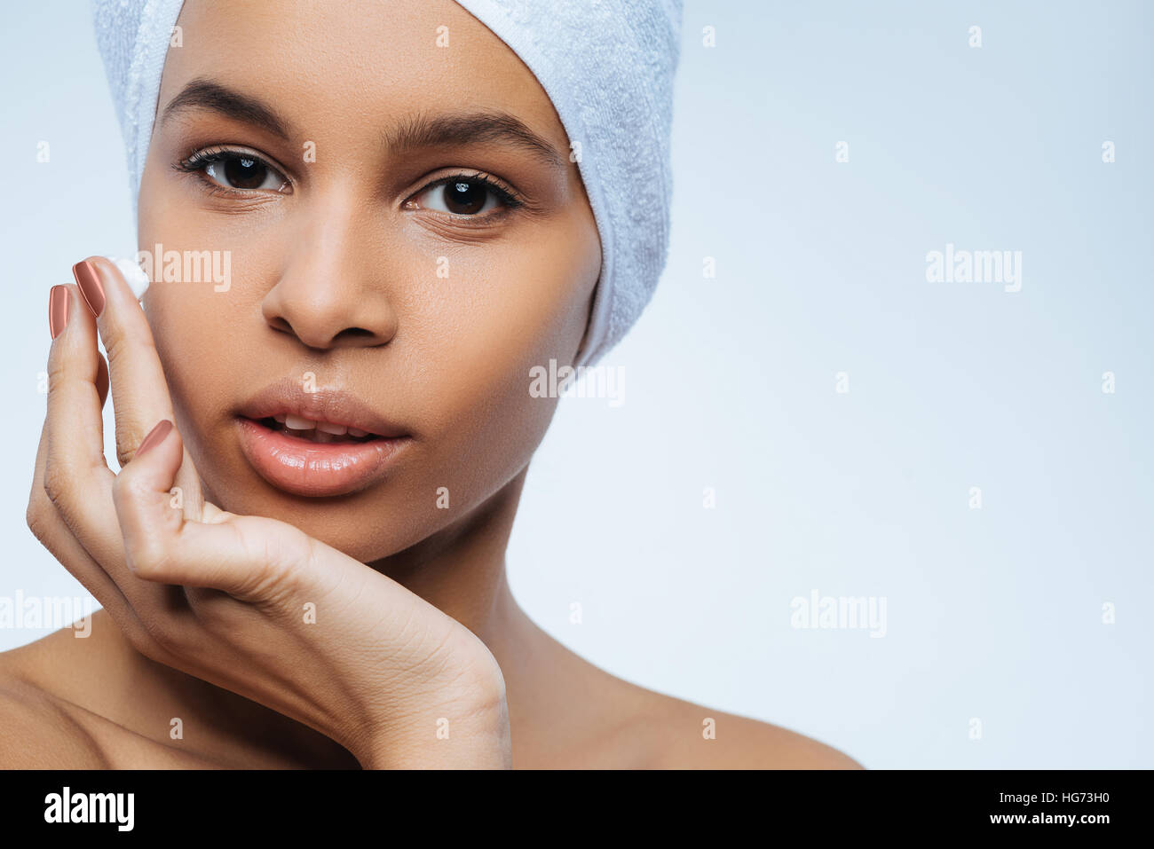 Good looking nice woman applying facial cream Stock Photo - Alamy