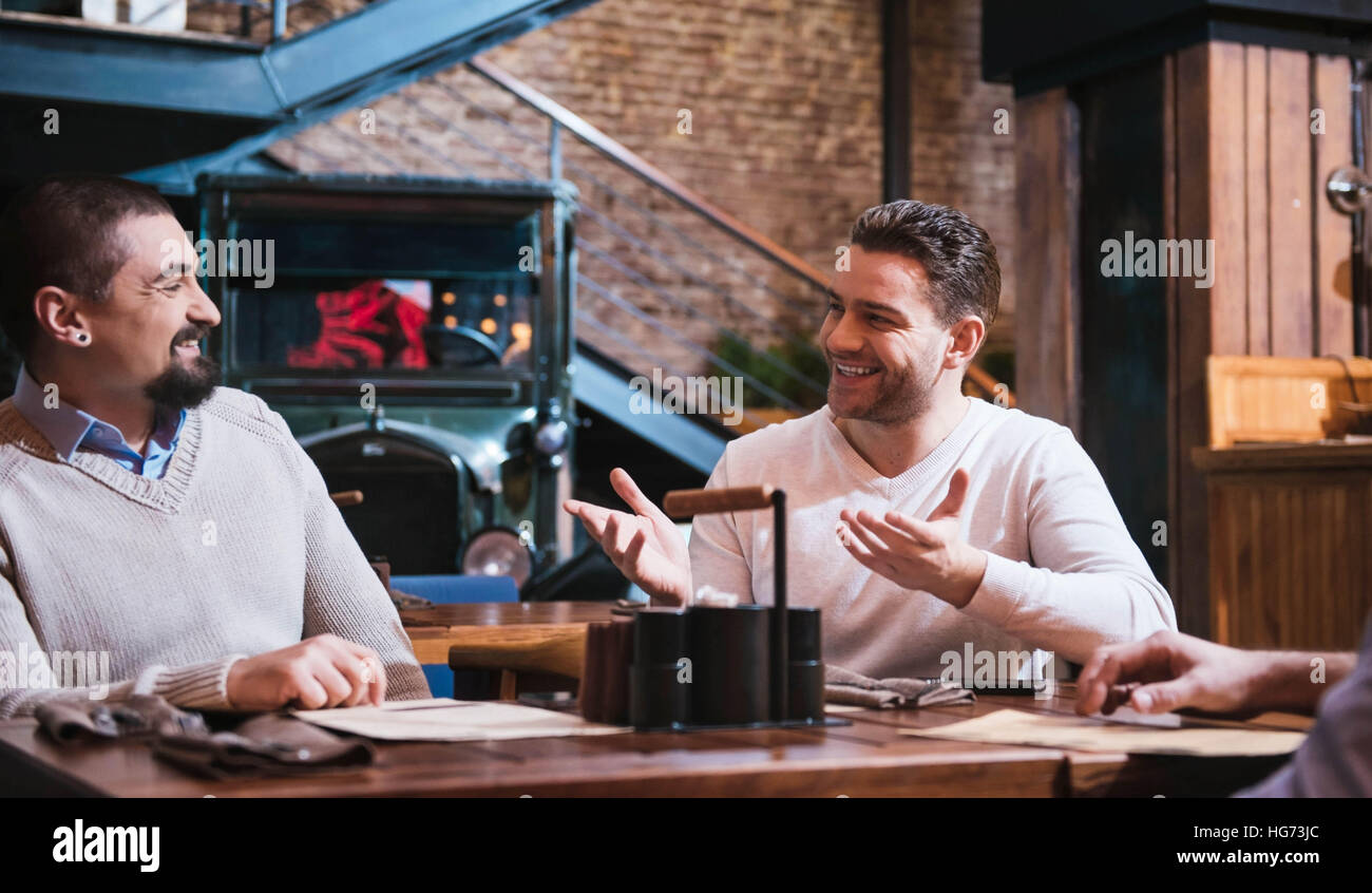 Handsome joyful man explaining something to a friend Stock Photo - Alamy Handsome joyful man explaining something to a friend Stock Photo - Alamy