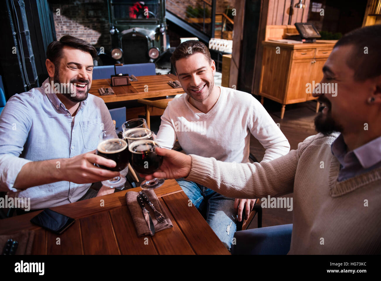 Happy positive man enjoying their drink Stock Photo - Alamy