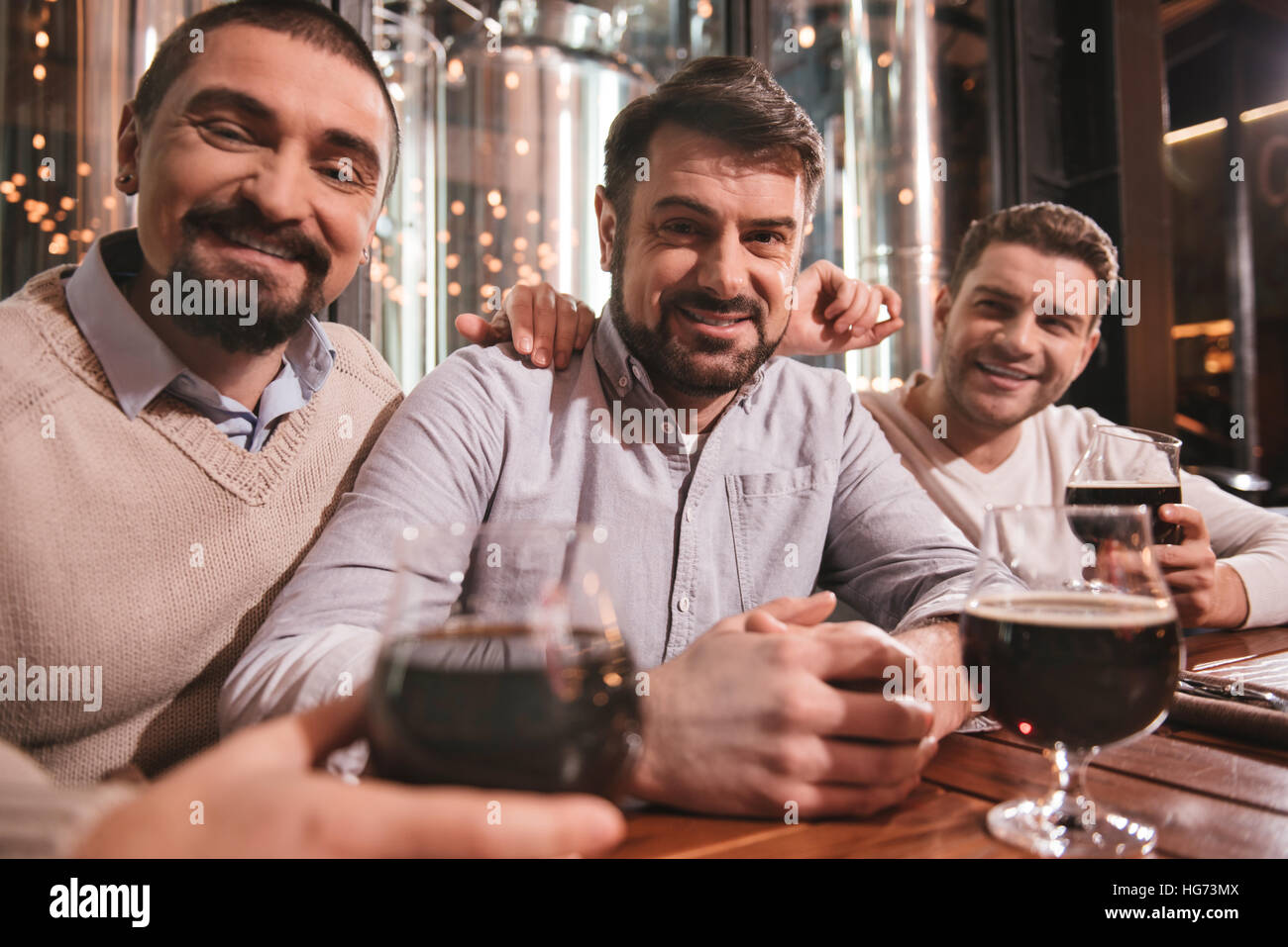 Handsome male friends sitting together Stock Photo - Alamy