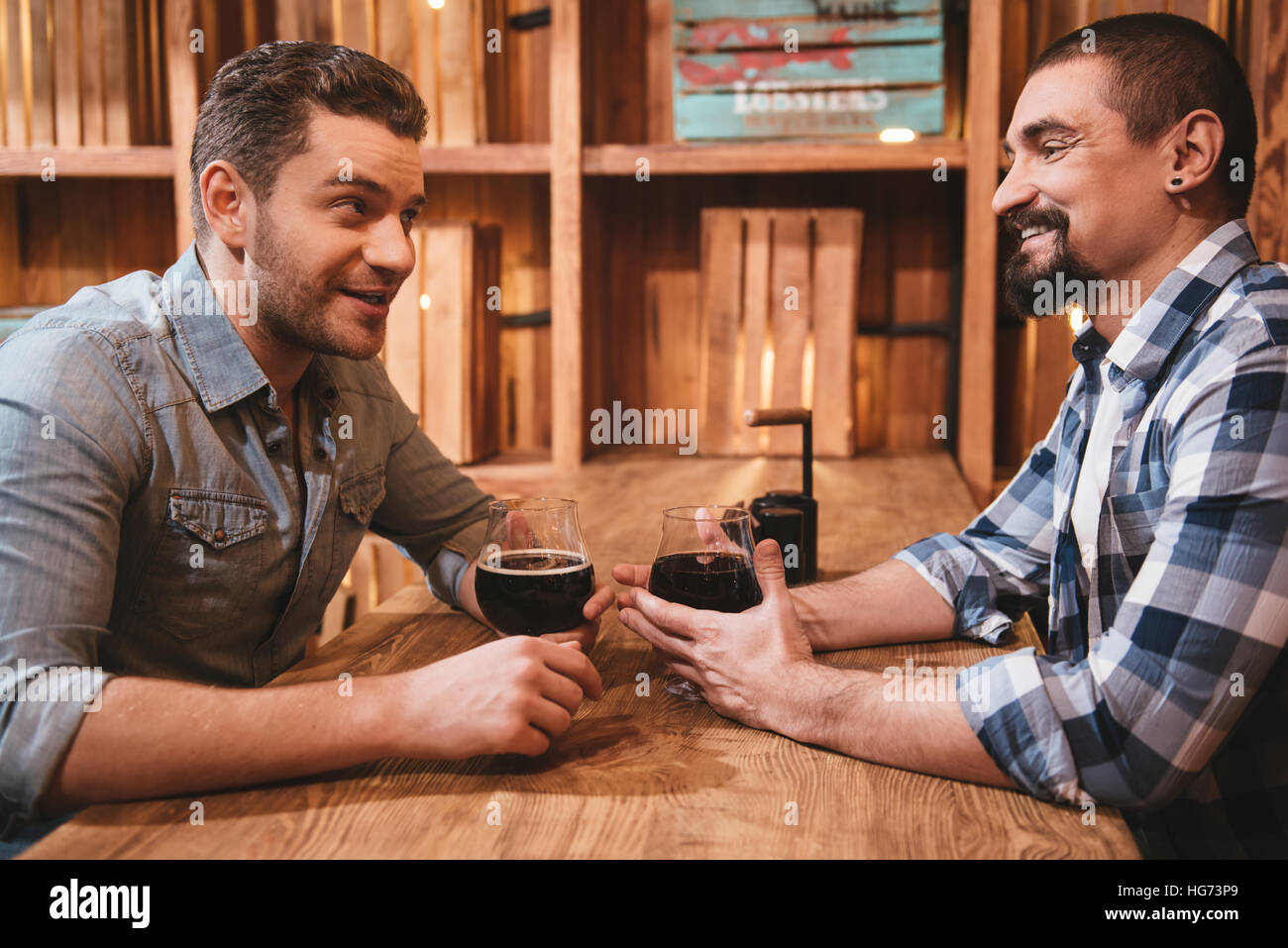 Positive nice friends speaking with each other Stock Photo - Alamy