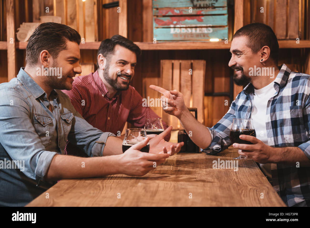 Cheerful positive men interacting with each other Stock Photo - Alamy