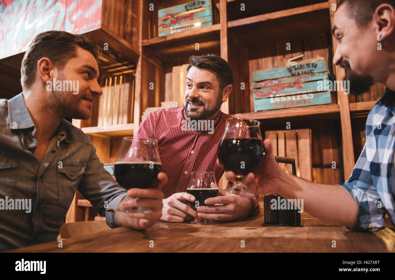 Cheerful pleasant men resting together Stock Photo - Alamy