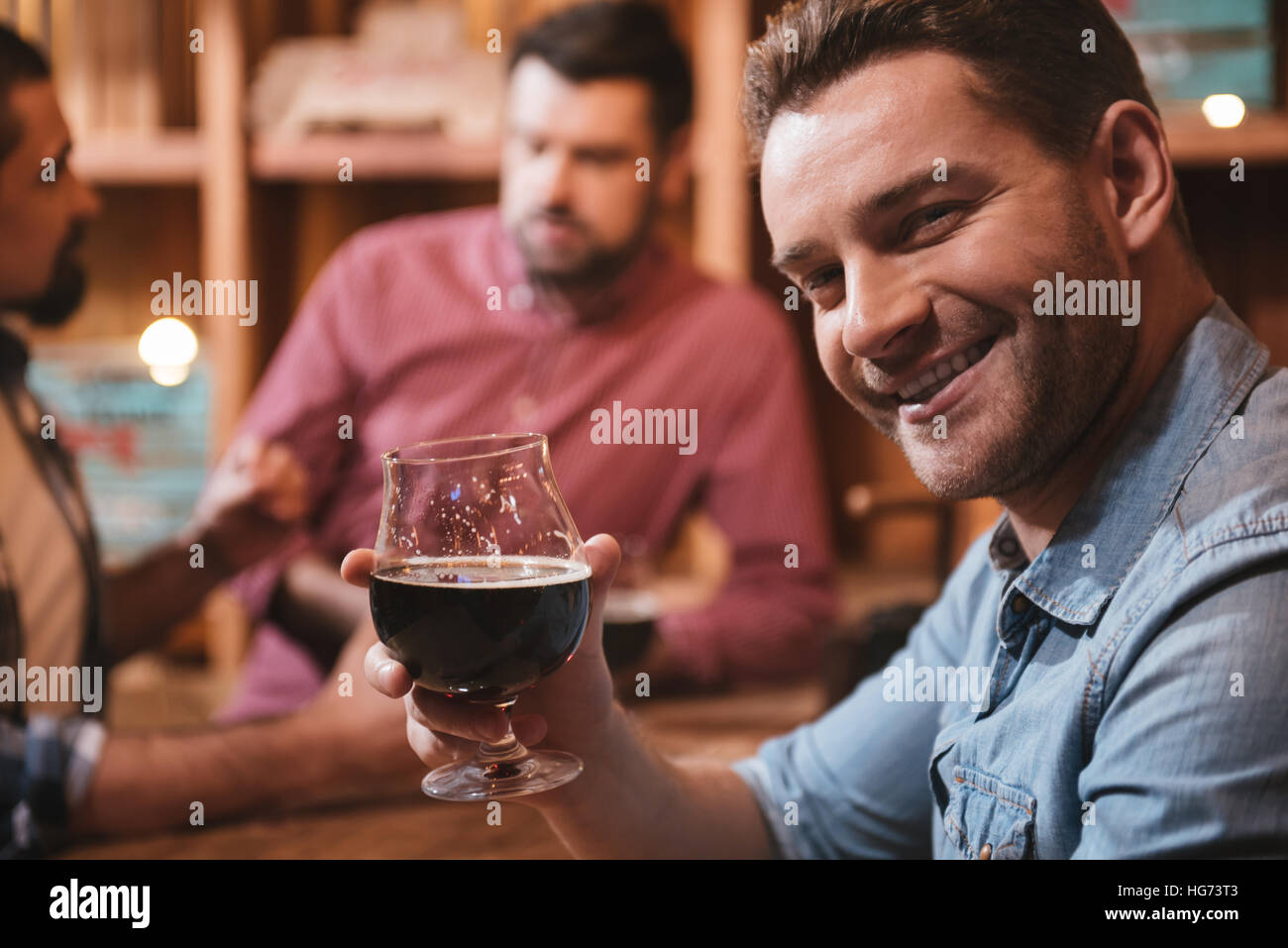 Handsome happy man drinking for you Stock Photo - Alamy