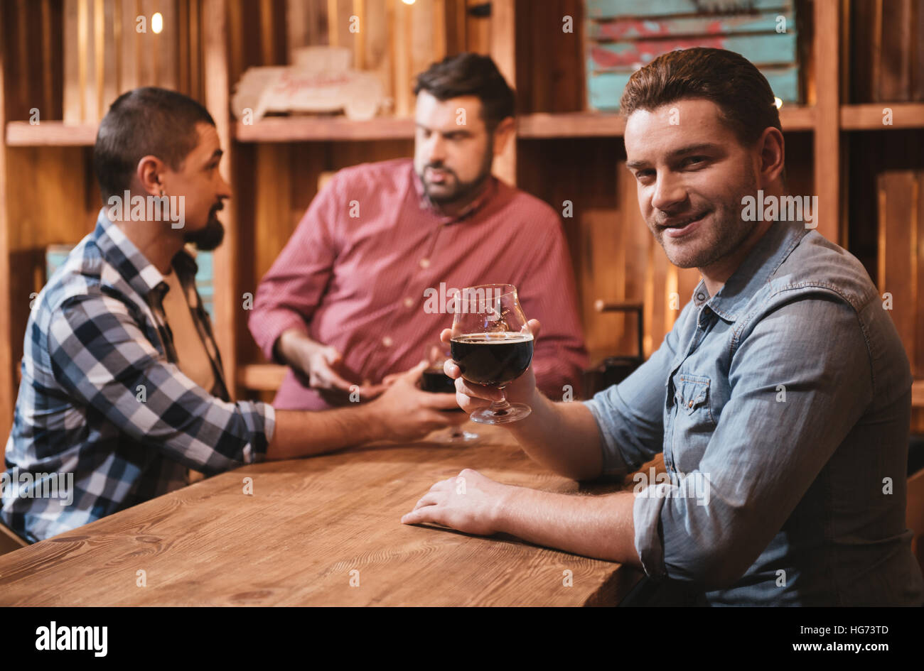 Positive joyful man sitting at the table Stock Photo - Alamy