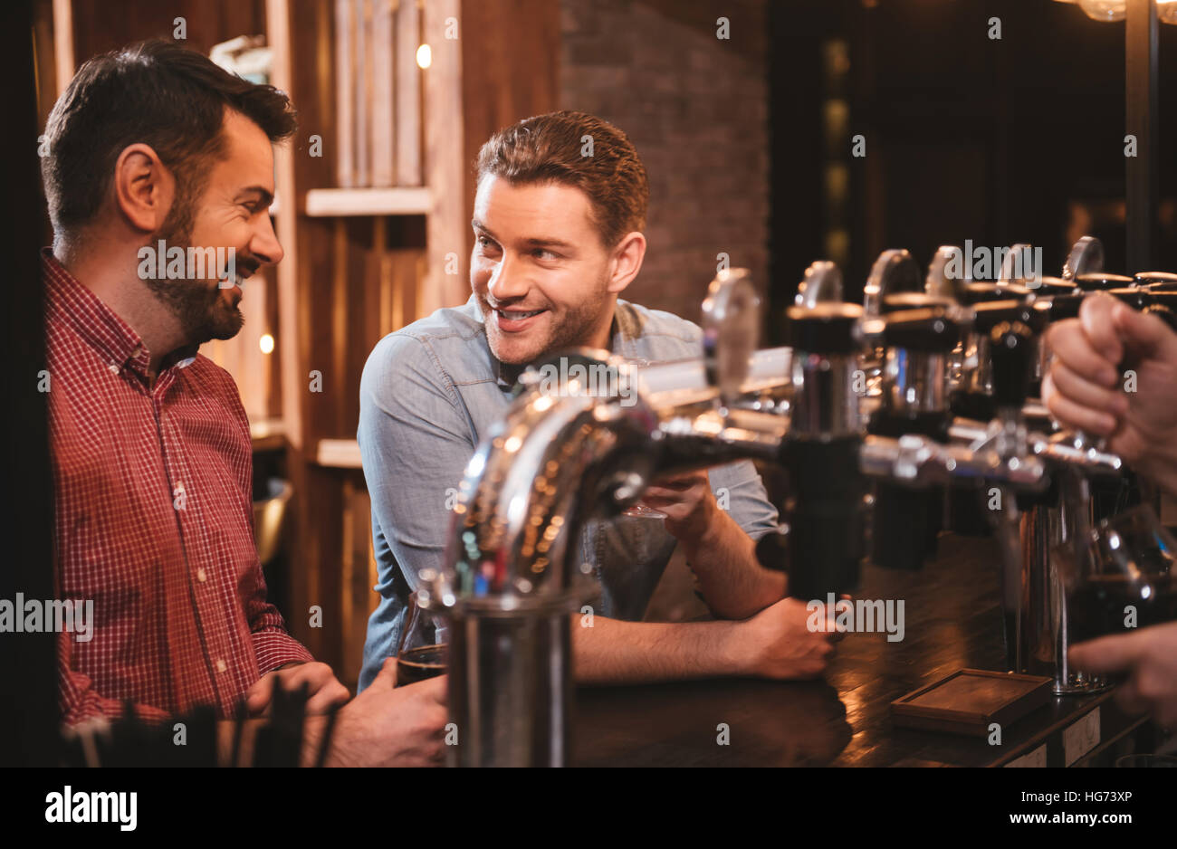 Handsome positive friends talking with each other Stock Photo - Alamy