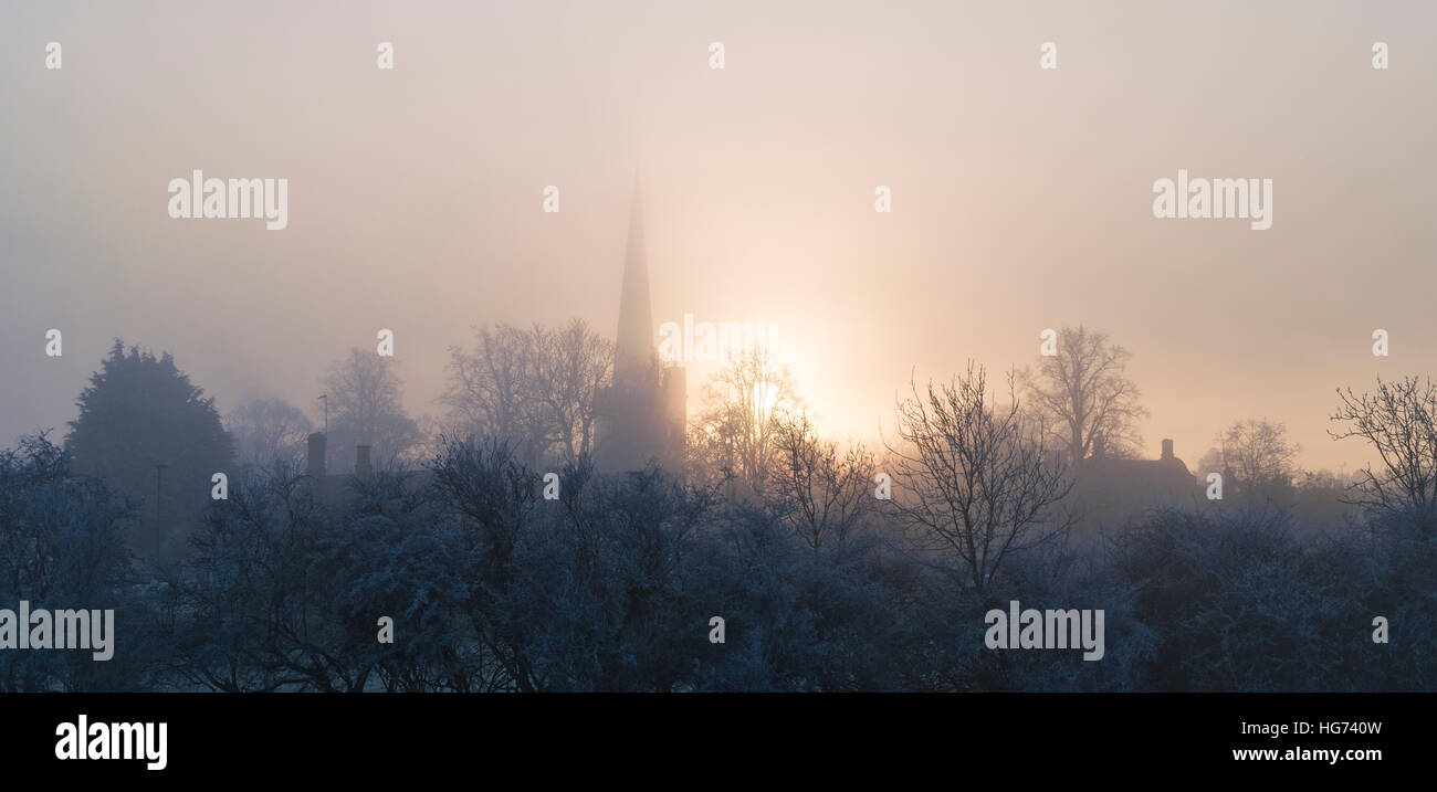Burford Church in thick frosty fog at sunrise in winter. Burford ...
