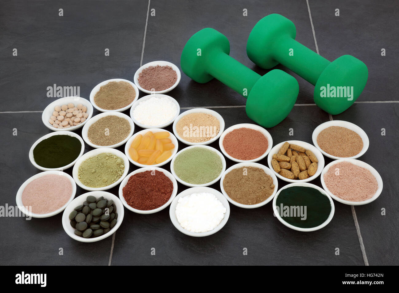 Body building powders, vitamin supplement pills and dumbbell weights ...