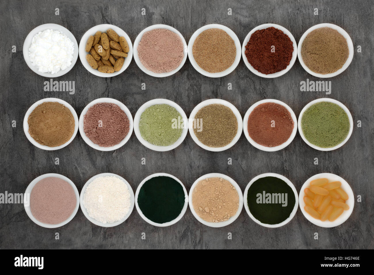 Body building powders and supplements in porcelain bowls over marble ...