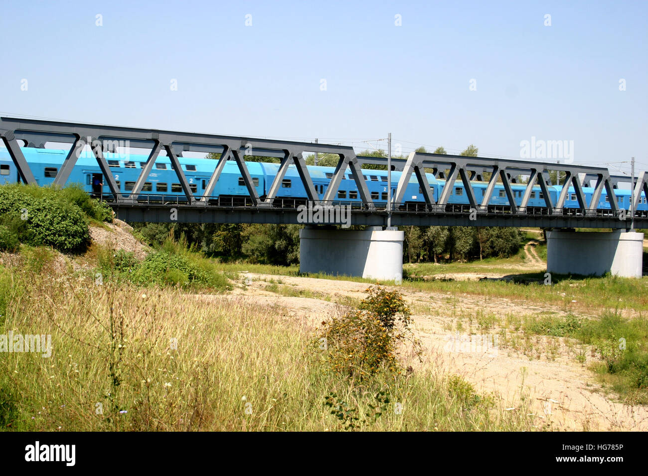 Double deck train passing on bridge Stock Photo - Alamy