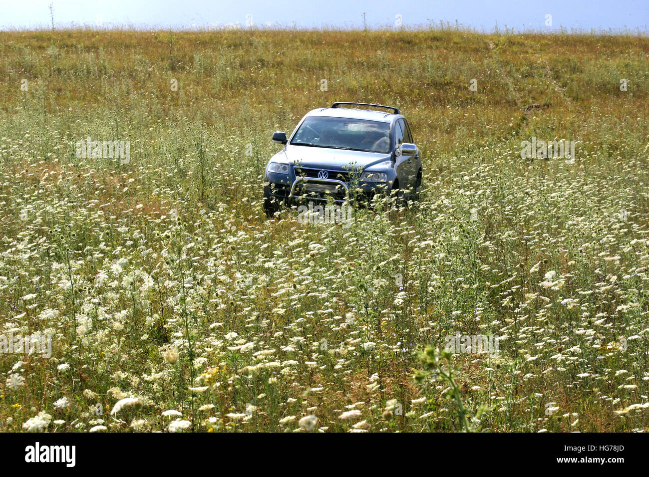 Vehicle driving through field Stock Photo - Alamy