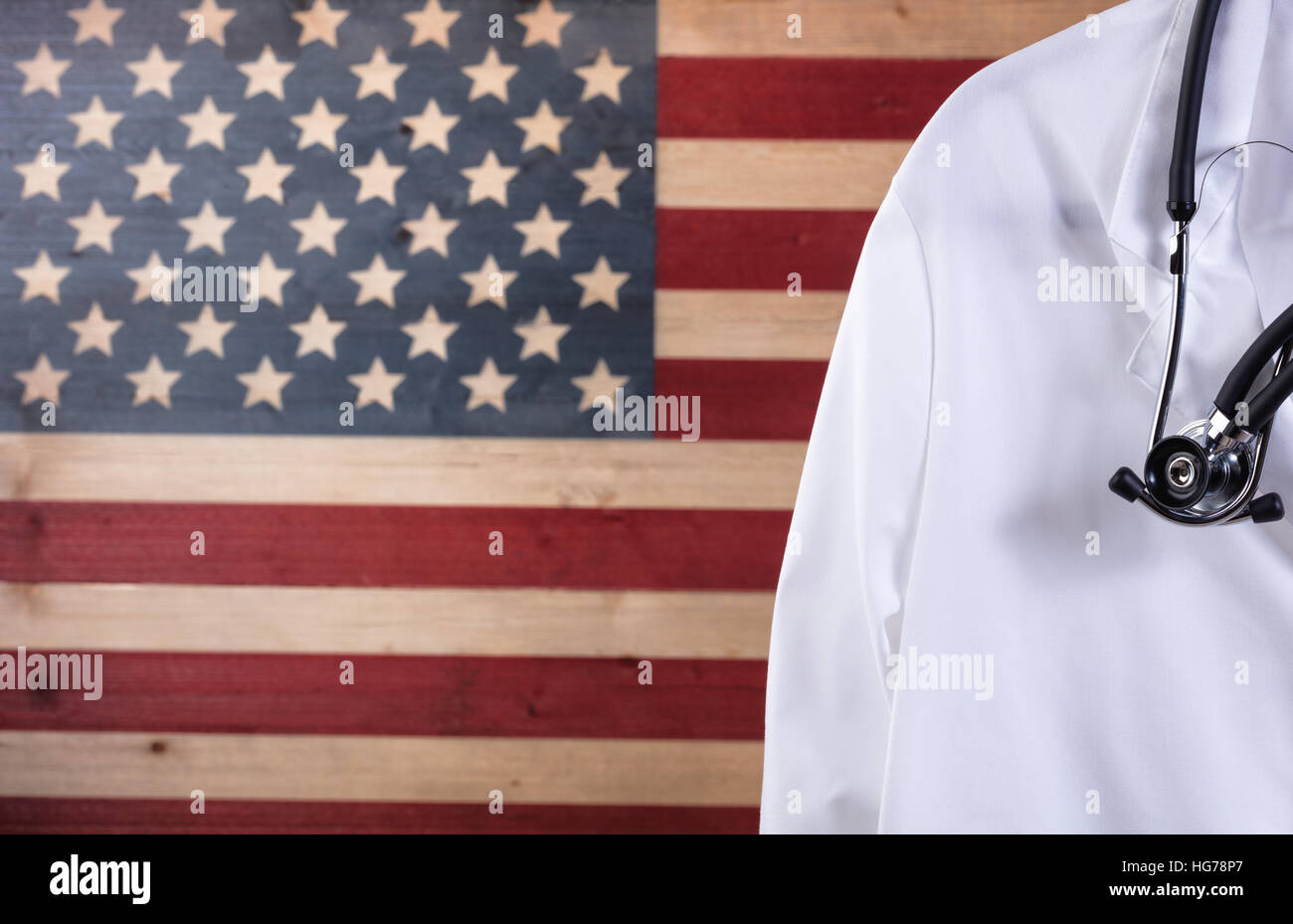 Closeup of medical doctor jacket with stethoscope against faded boards ...