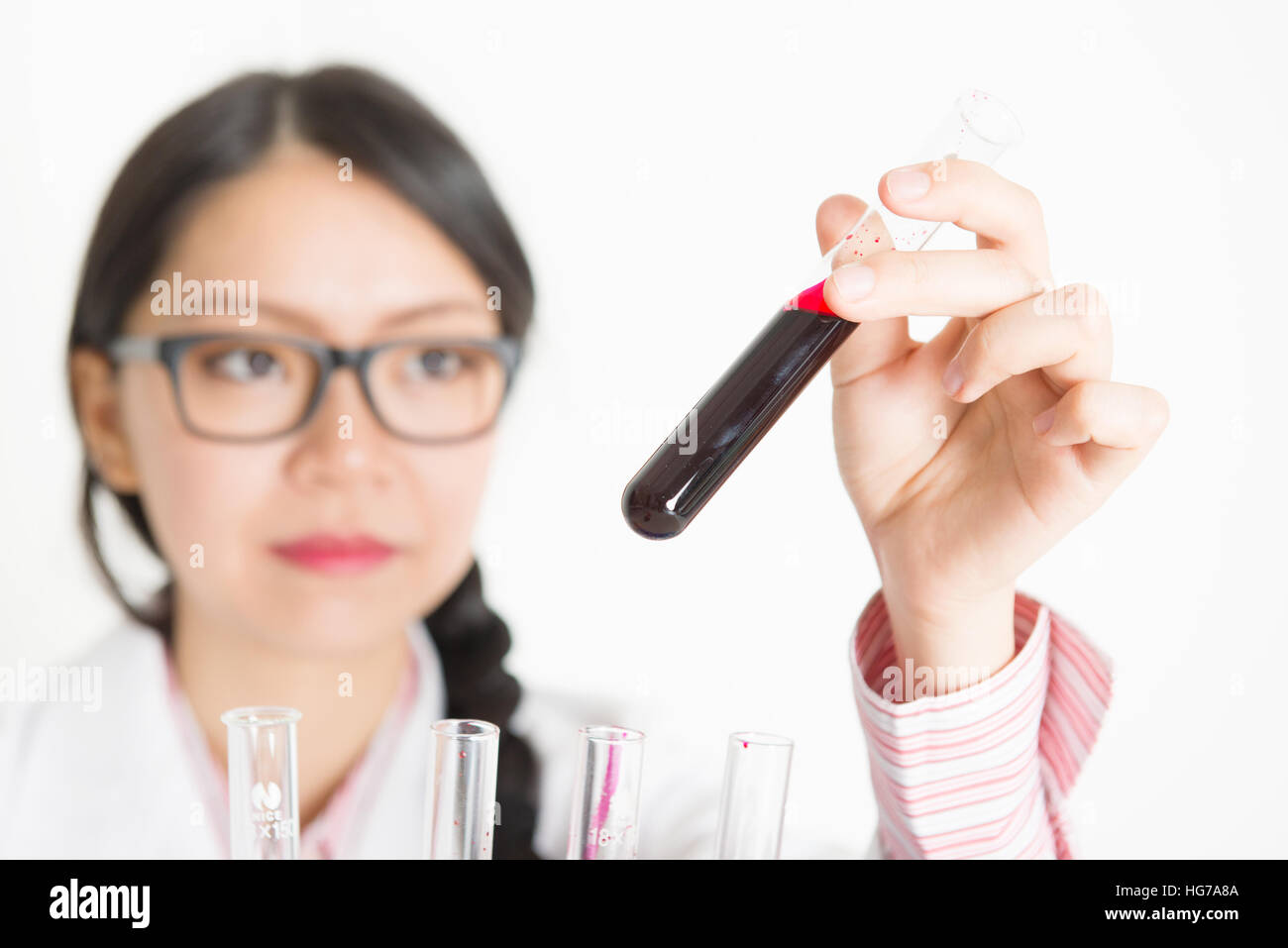 Female chemist checking blood hi-res stock photography and images - Alamy