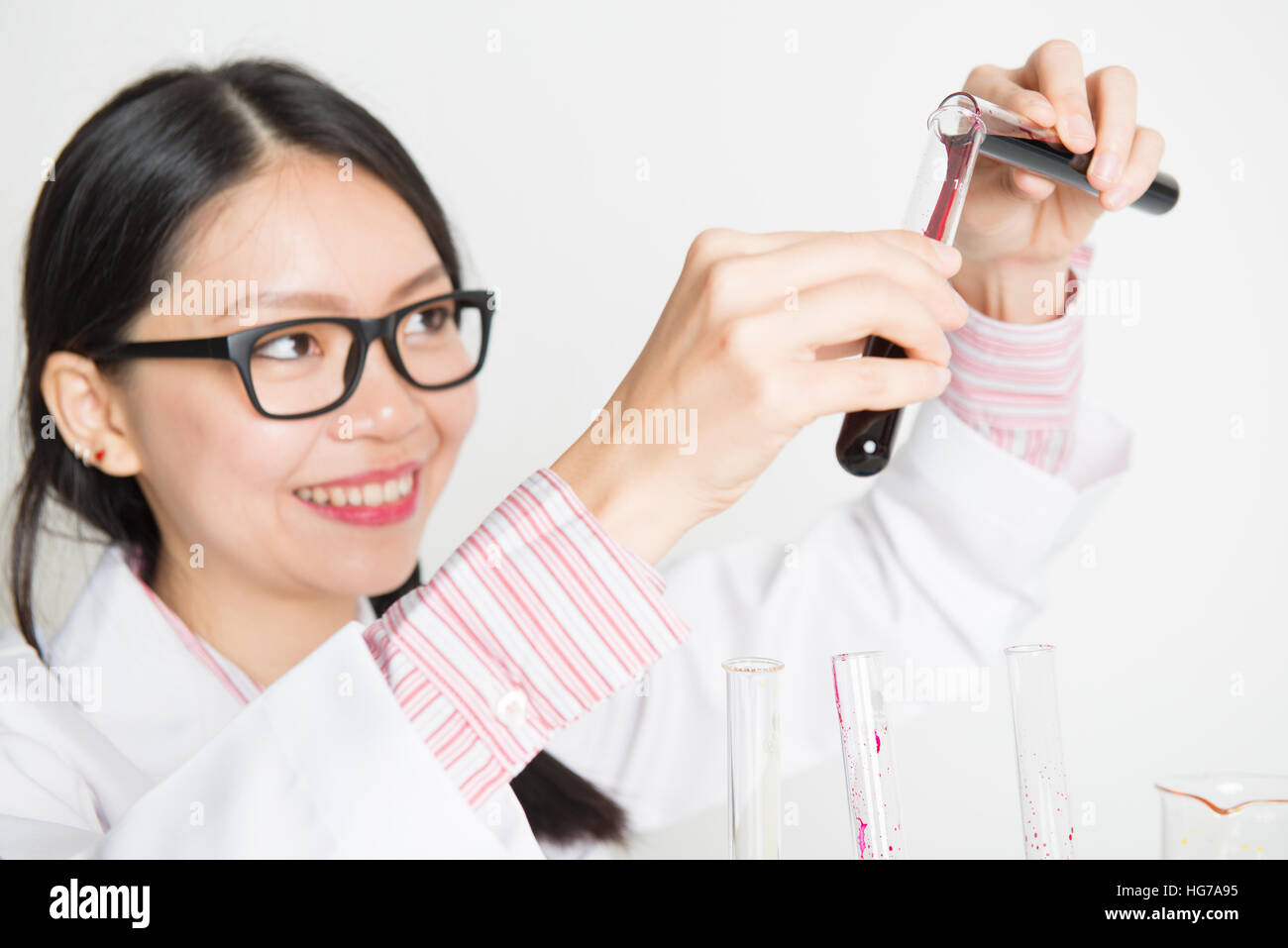 Attractive Asian female researcher carrying out scientific research in ...