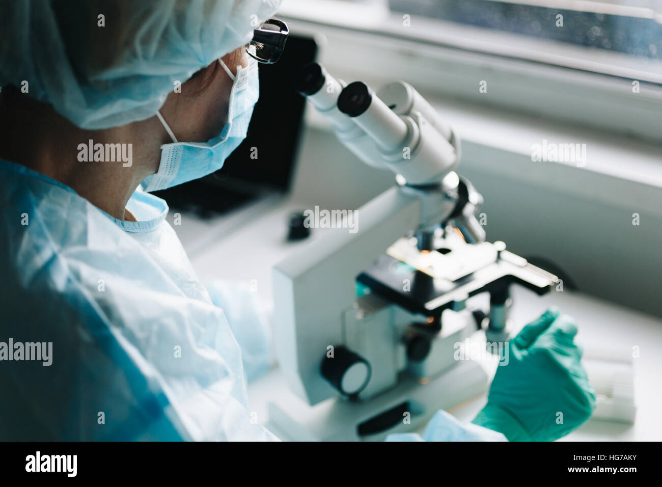 Scientist working in laboratory with microscope Stock Photo - Alamy