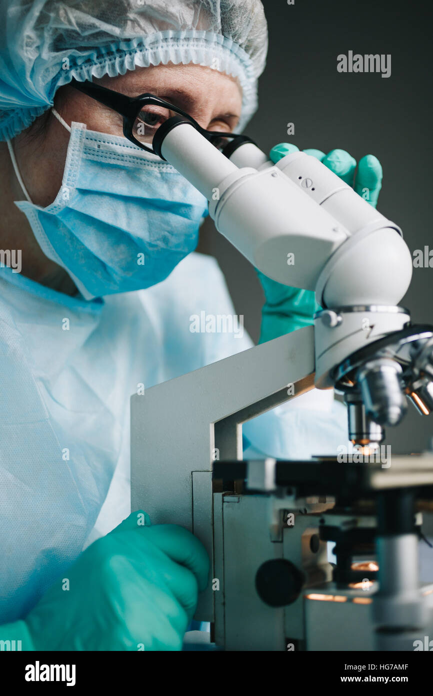 Scientist working in laboratory with microscope Stock Photo - Alamy