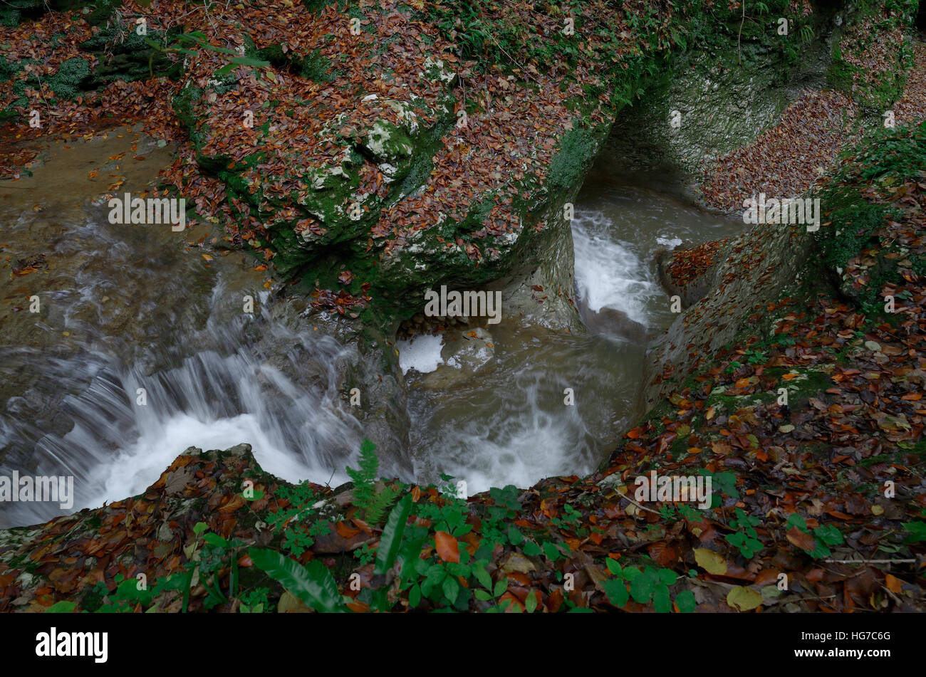 Small waterfall on a mountain stream in the fall, clean water. An ...