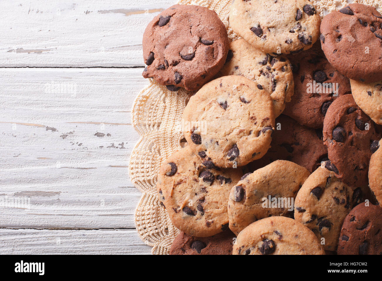 A pile of homemade chocolate chips cookies on the table. horizontal ...