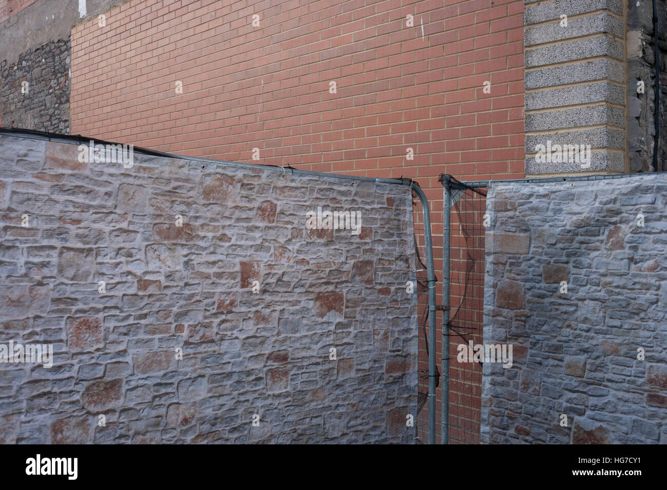 A construction screen featuring a printed pattern of brickwork, outside ...