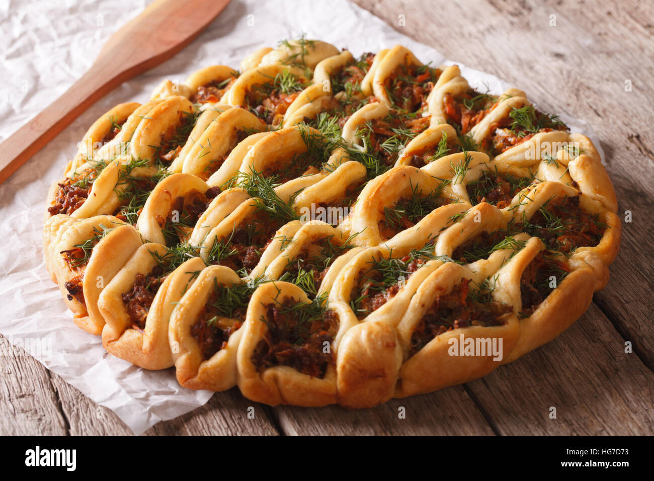 Open pie with ground meat and vegetables close-up on the table ...