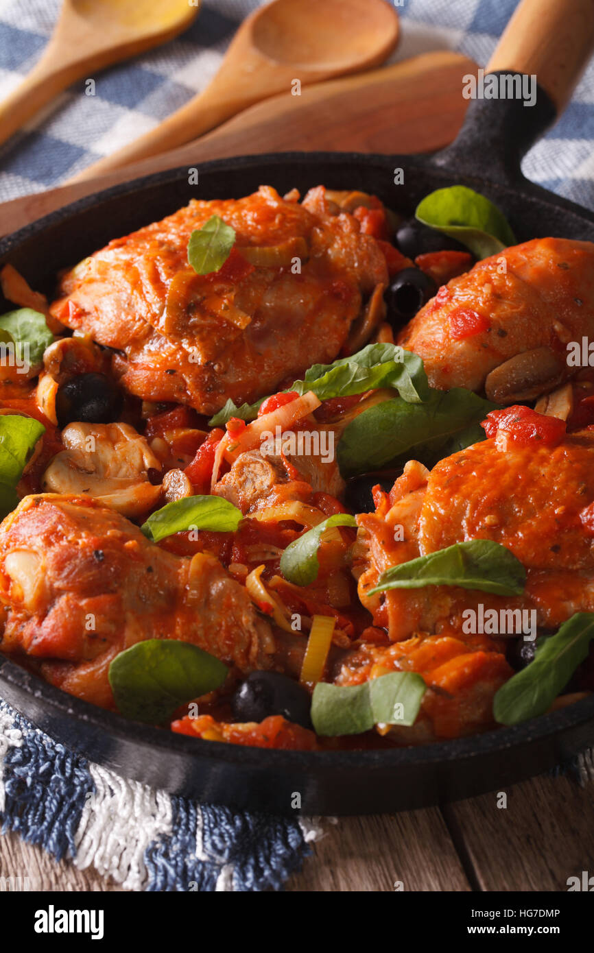 Italian food: chicken with tomato and vegetables close-up in a frying ...