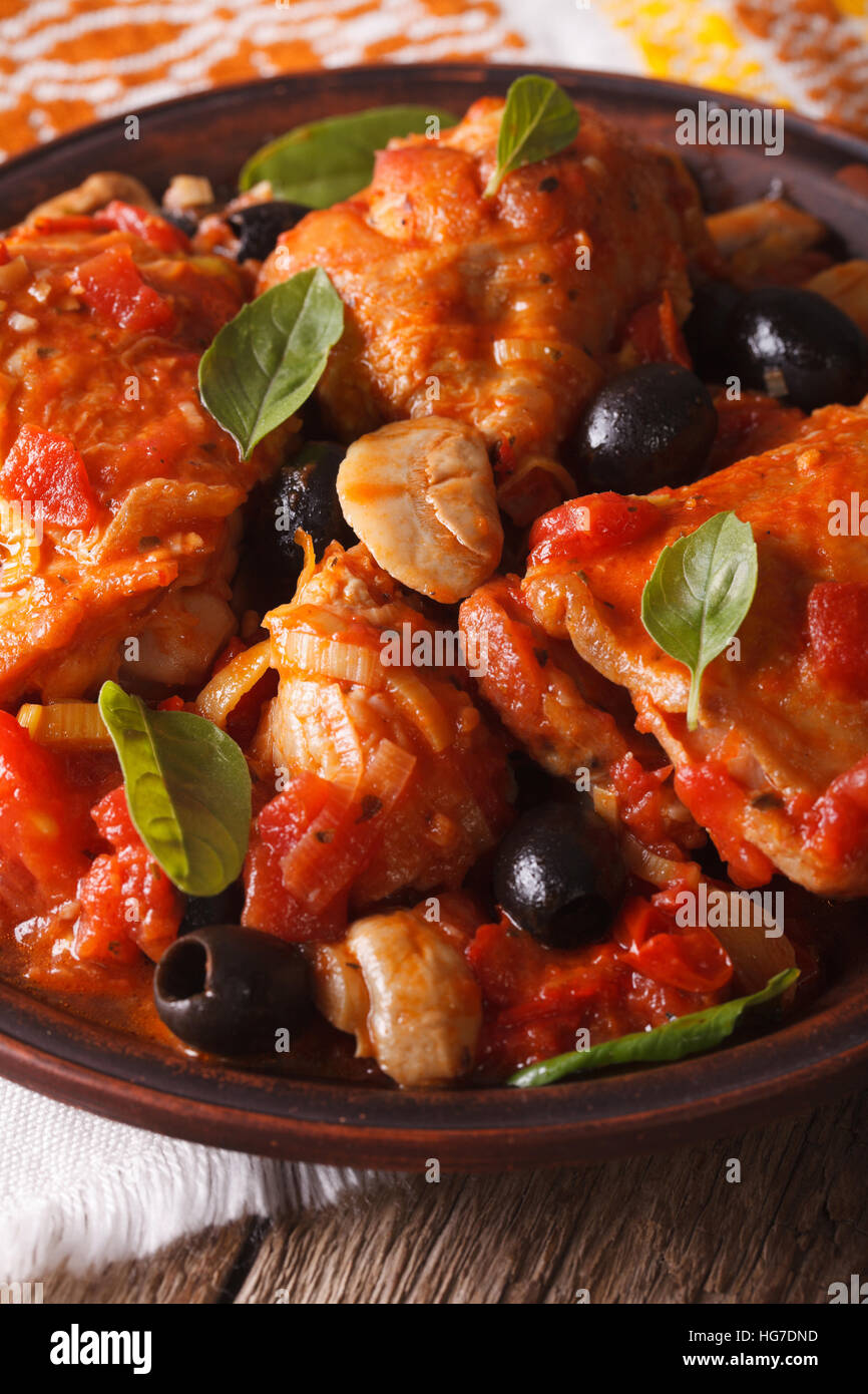 Italian food: Chicken Cacciatori with basil on a plate close-up ...