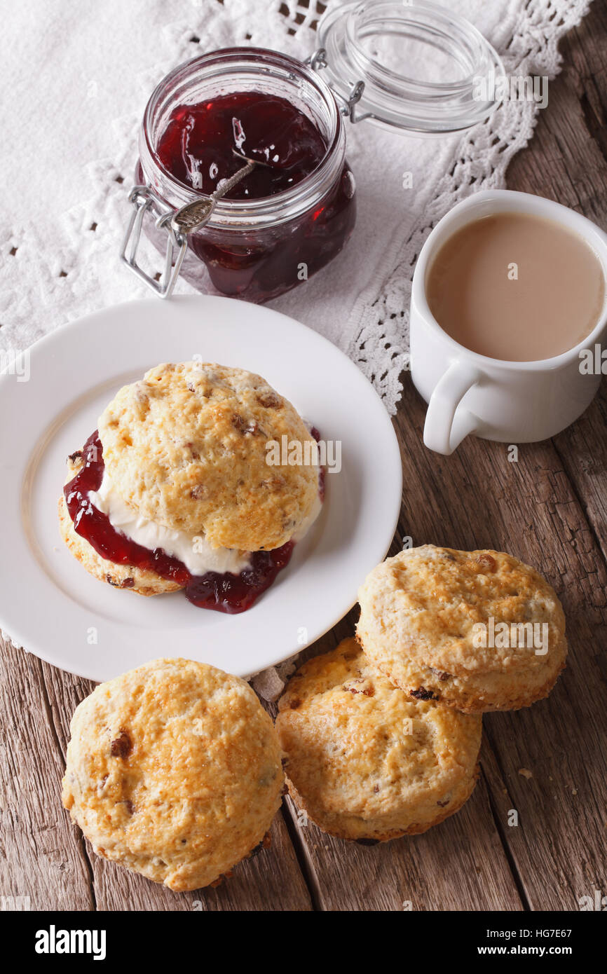 Homemade buns with jam and tea with milk close-up on the table ...