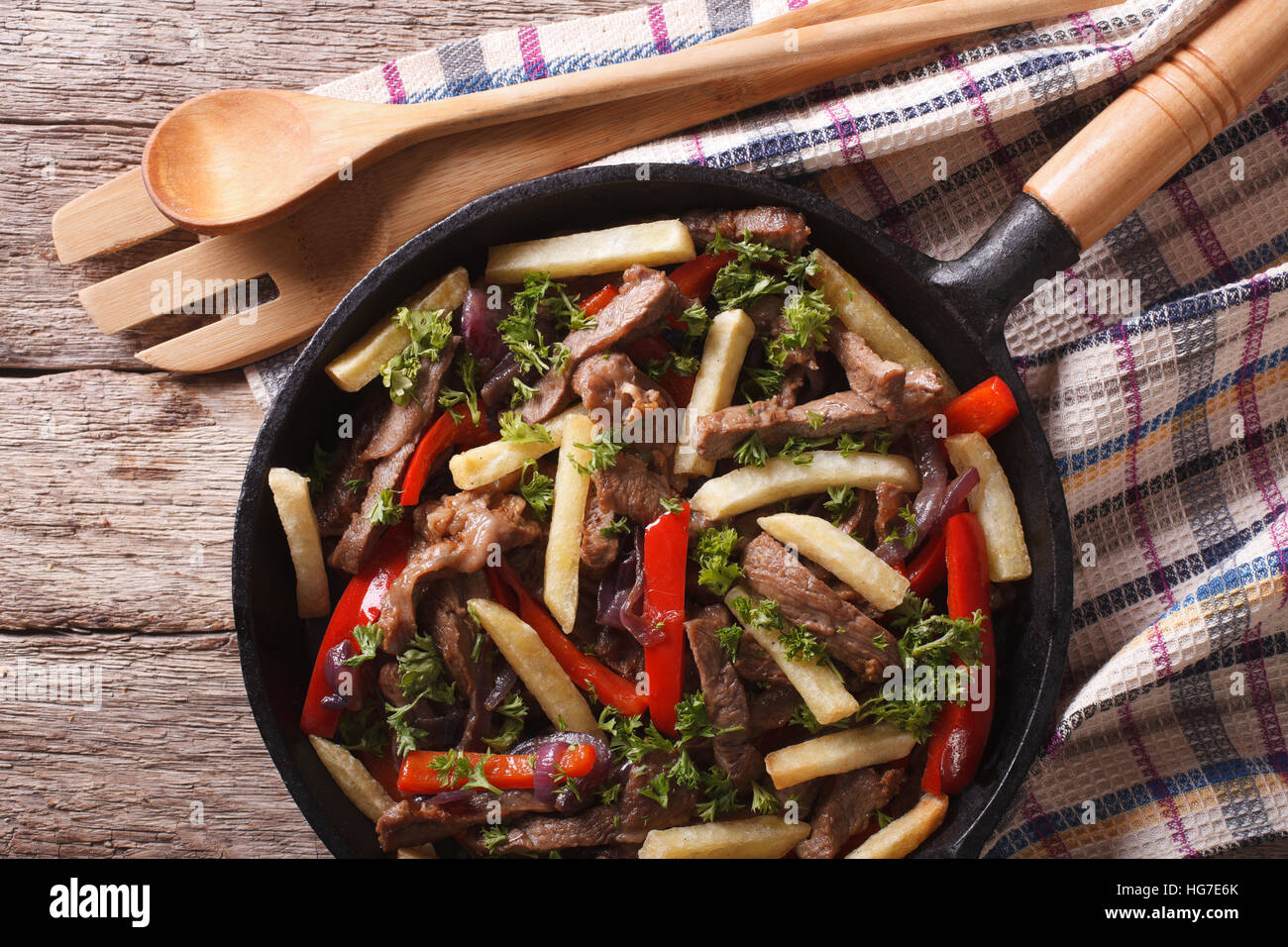 Homemade Peruvian Food: Lomo saltado close-up in a frying pan ...