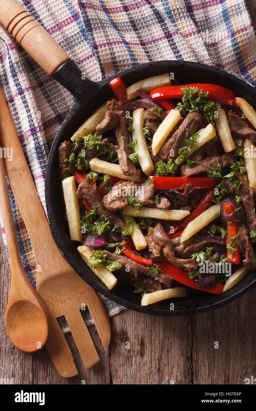 Homemade Peruvian Food: Lomo saltado close-up in a frying pan. vertical ...