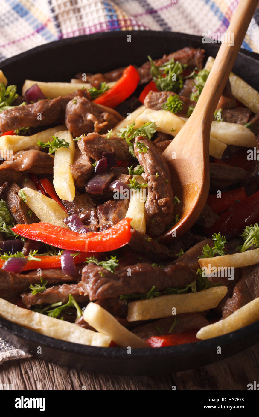 Homemade Peruvian Food: Lomo saltado close-up in a frying pan. vertical ...