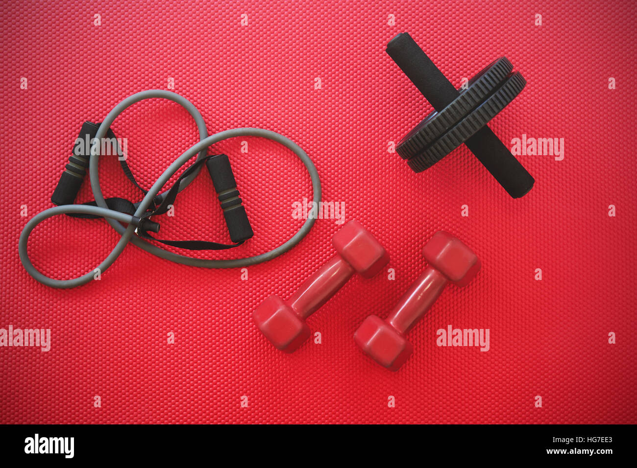 Gym equipment on red mat background, top view Stock Photo - Alamy