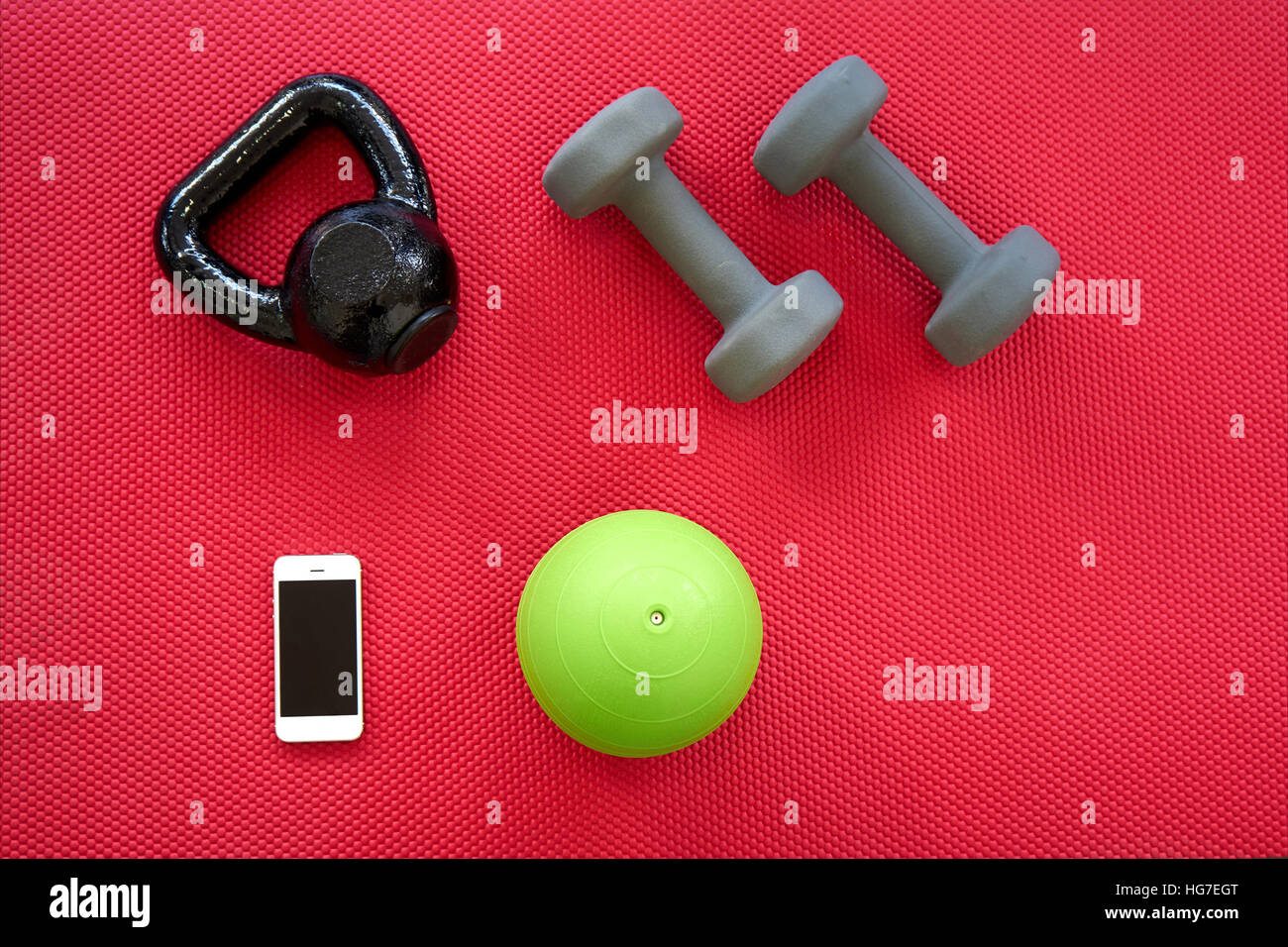 Gym equipment on red mat background, top view Stock Photo - Alamy