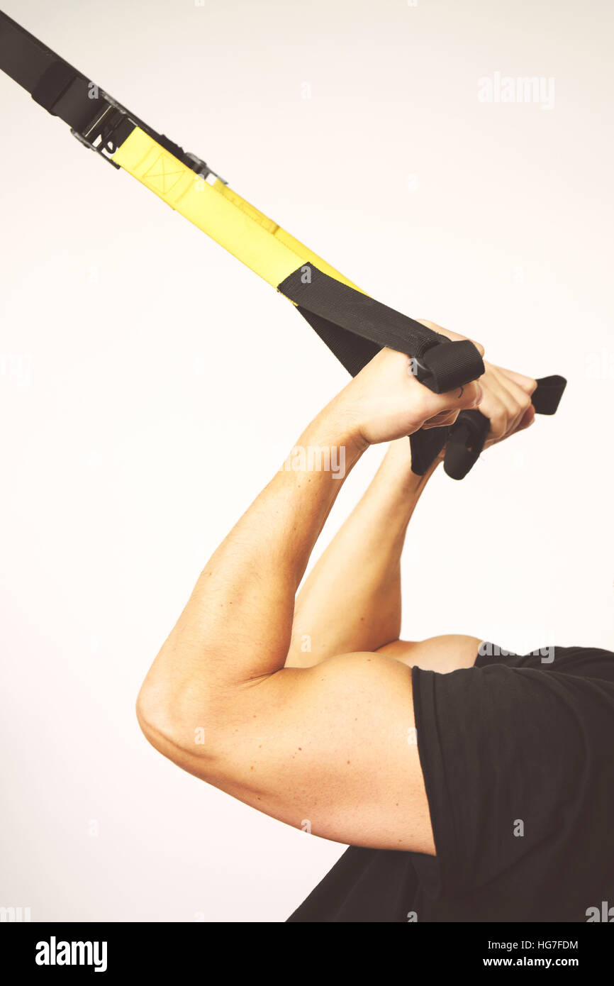 TRX. Male hands with fitness TRX straps in gym Stock Photo - Alamy
