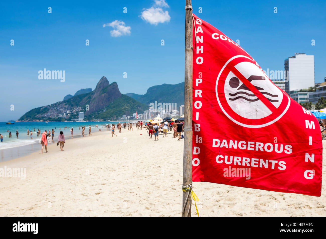 Swim warning flag flutters on a sunny Ipanema beach. 'Banho Probido ...